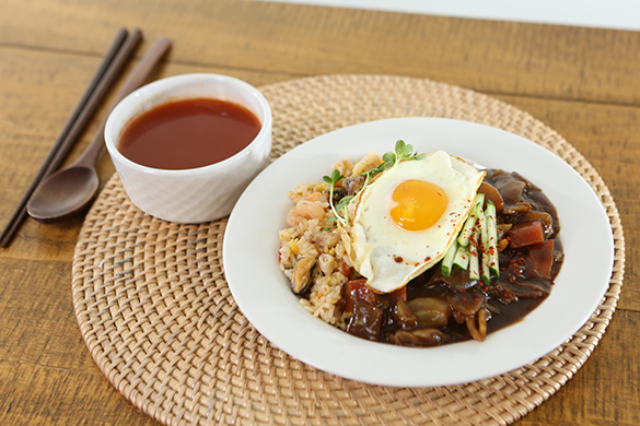 6. Pour Jjajang sauce on the side of seafood fried rice.